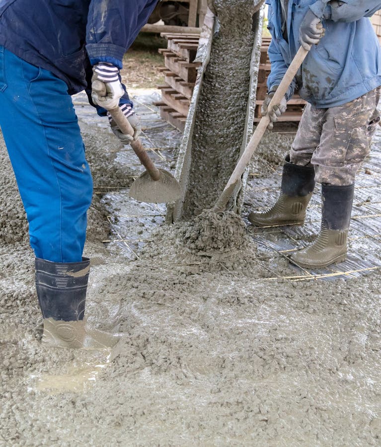 Workers Level Out the Concrete Mix at a Construction Site. Stock Image ...