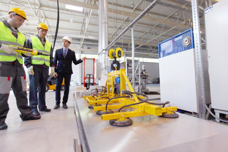 Workers and lifting device stock photo. Image of lifting - 75792508