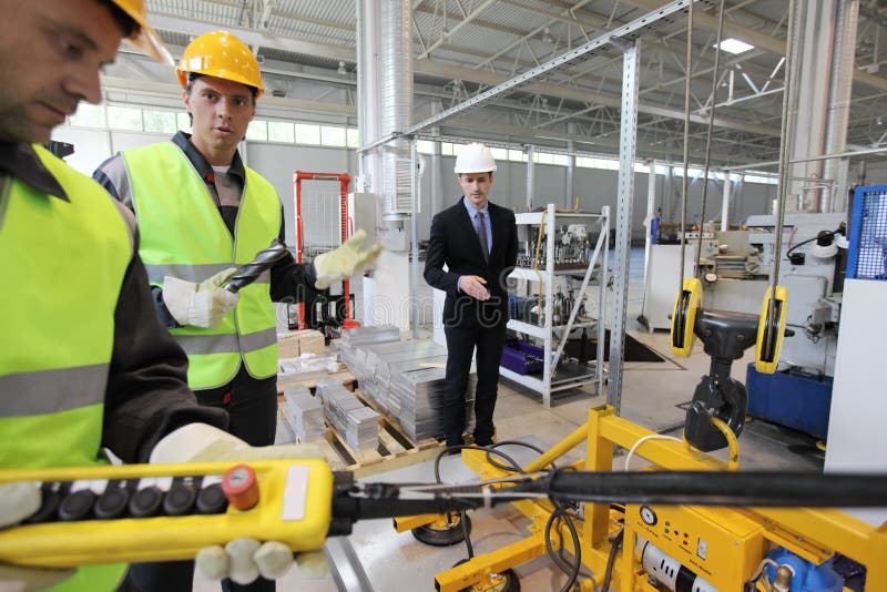 Workers and lifting device stock photo. Image of plate - 78568778