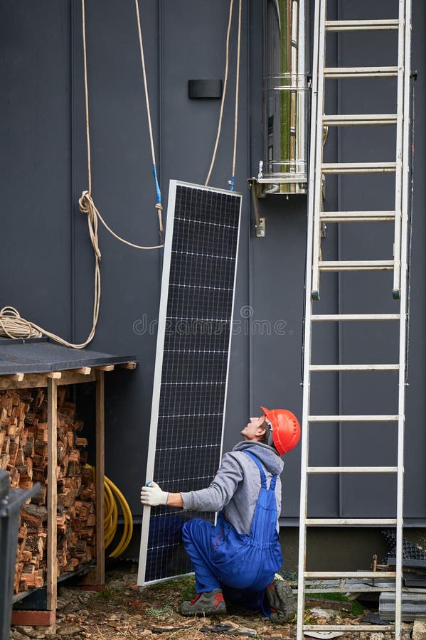 Workers Lifting Up Photovoltaic Solar Module while Installing Solar ...