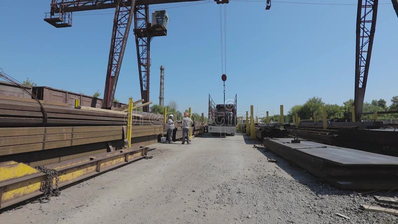Workers Load Metal into a Truck, People Work in a Warehouse, Load Cargo ...