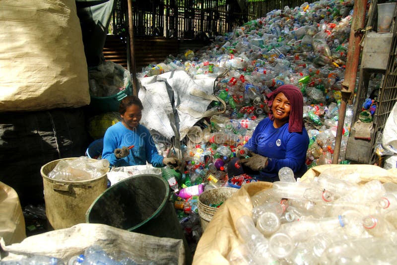 Workers of a Materials Recovery Facility Sort through Plastic Waste and ...