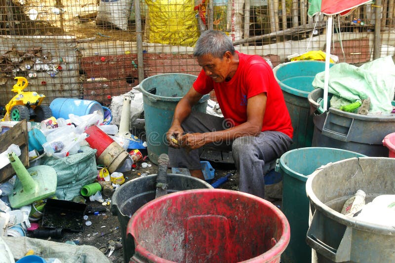 Workers of a Materials Recovery Facility Sort through Plastic Waste and ...