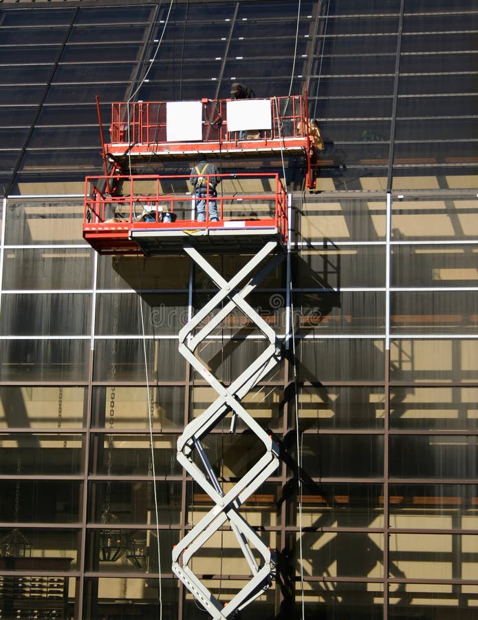 Workers on mechanical lift stock photo. Image of windows - 1929596
