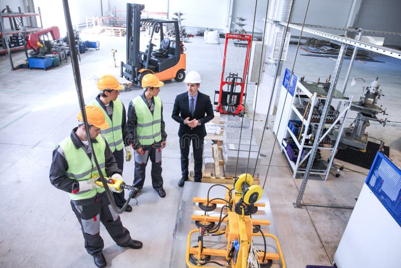 Workers with Metal Sheet Lifting Device Stock Photo - Image of ...