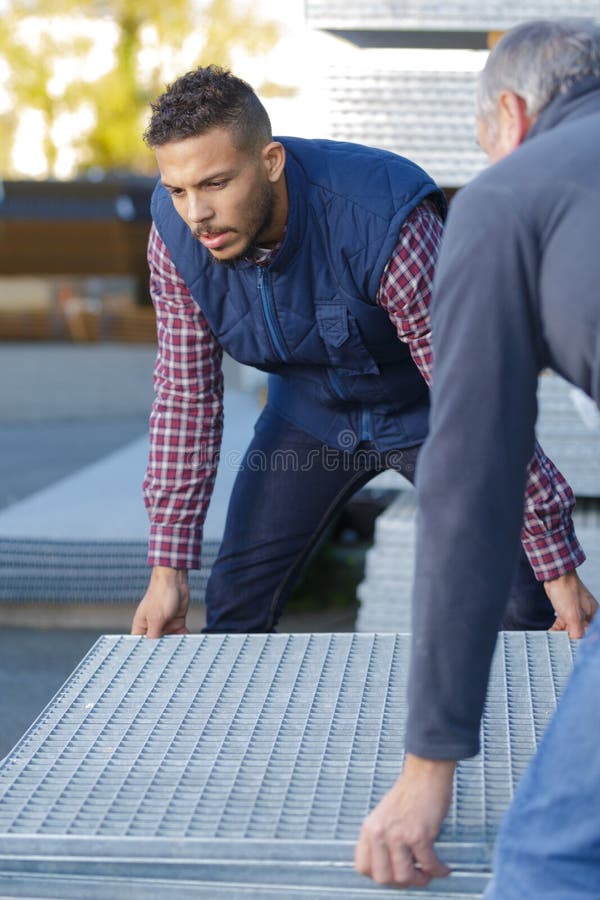 Workers Moving Metal Sheets Outside Factory Stock Image - Image of ...