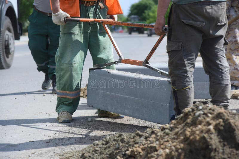 Workers are Moving the Road Curb. Stock Image - Image of brick, cement ...