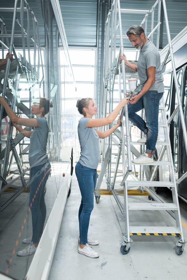 Workers Next To Aluminum Ladder at Warehouse Stock Photo - Image of ...