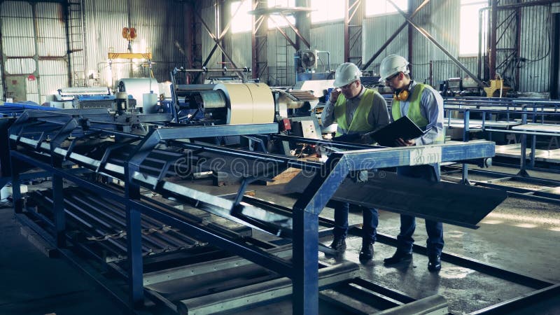 Workers are Observing a Factory Conveyor with Metal Shingles Stock ...