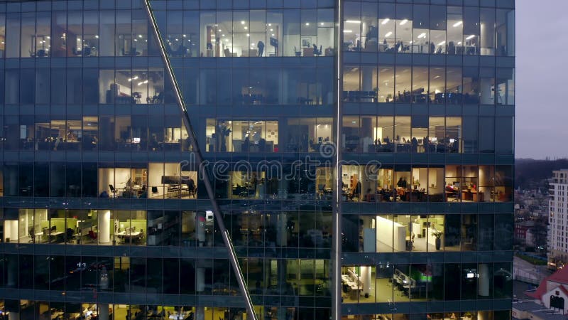 Office Building at Night with People Working Inside the Night ...