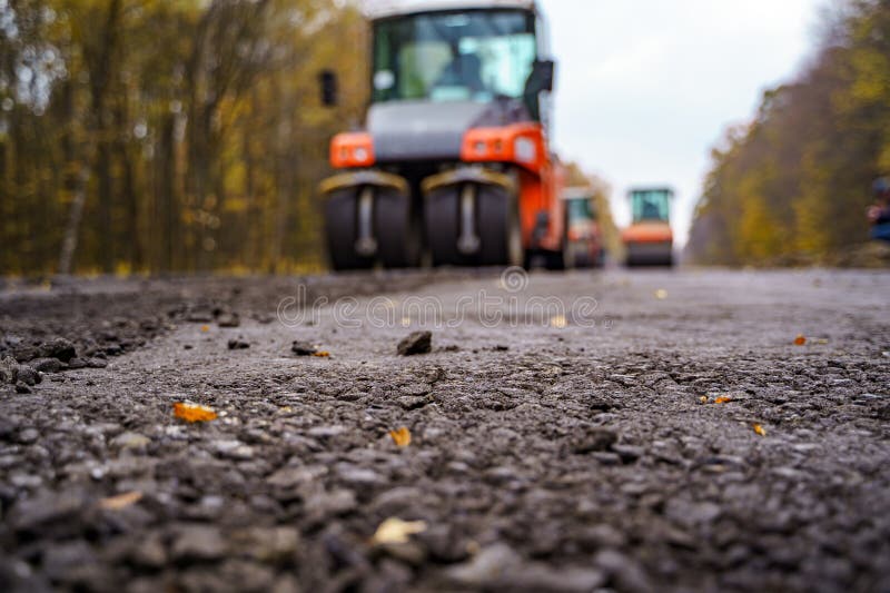 Workers Operating Asphalt Paver Machine during Road Construction. Stock ...