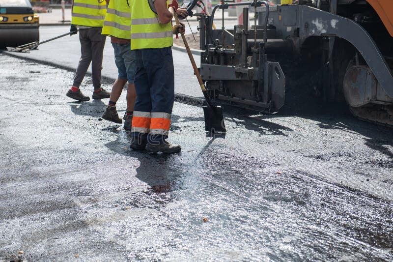 Workers Operating Asphalt Paver Machine during Road Construction and ...