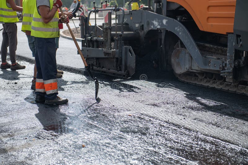 Workers Operating Asphalt Paver Machine during Road Construction and ...