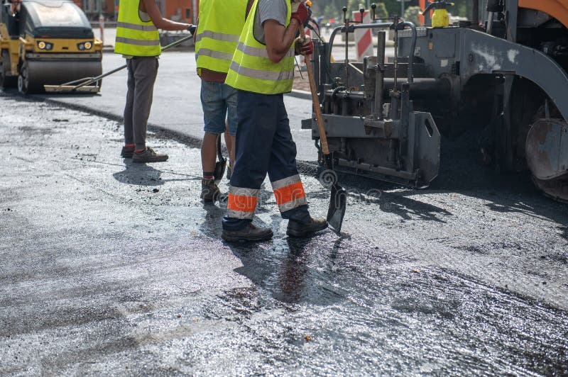 Workers Operating Asphalt Paver Machine during Road Construction and ...