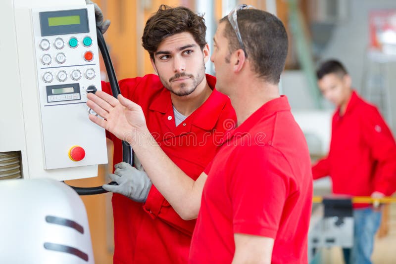 Workers Operating Machine in Factory Stock Photo - Image of male ...
