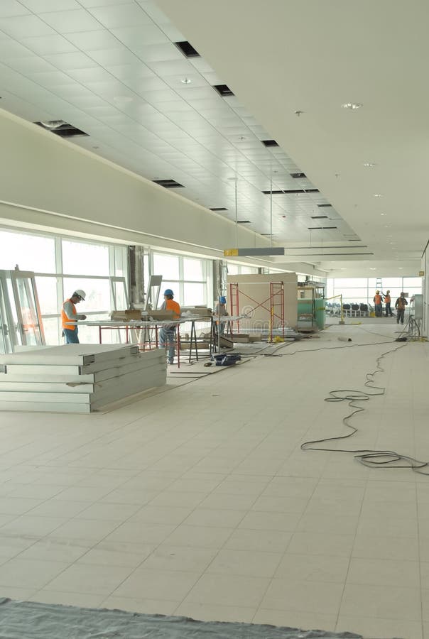 Workers Organizing Work Material within a Construction. Editorial ...