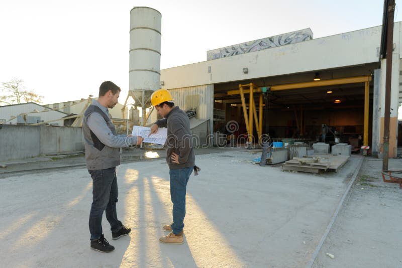 Workers outside factory stock photo. Image of project - 99327258