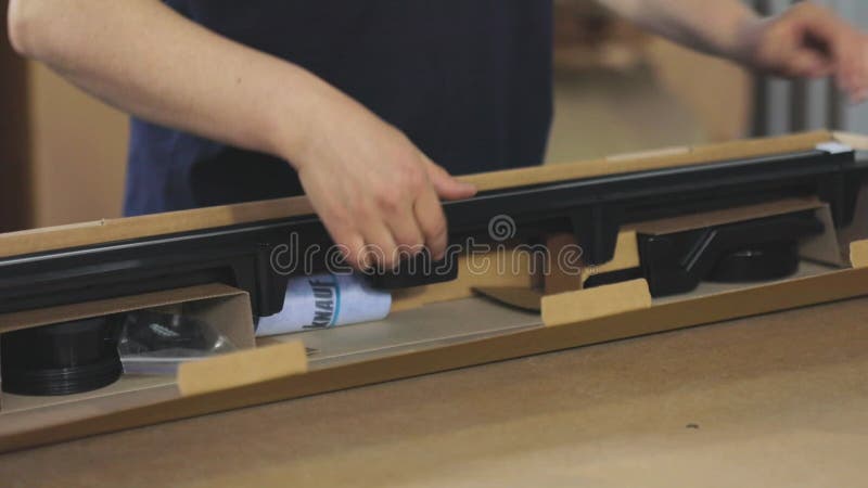 Workers Pack Finished Products into a Box. Packaging of Finished Goods ...