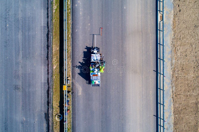 Workers painting the lines stock image. Image of machinery - 90648013