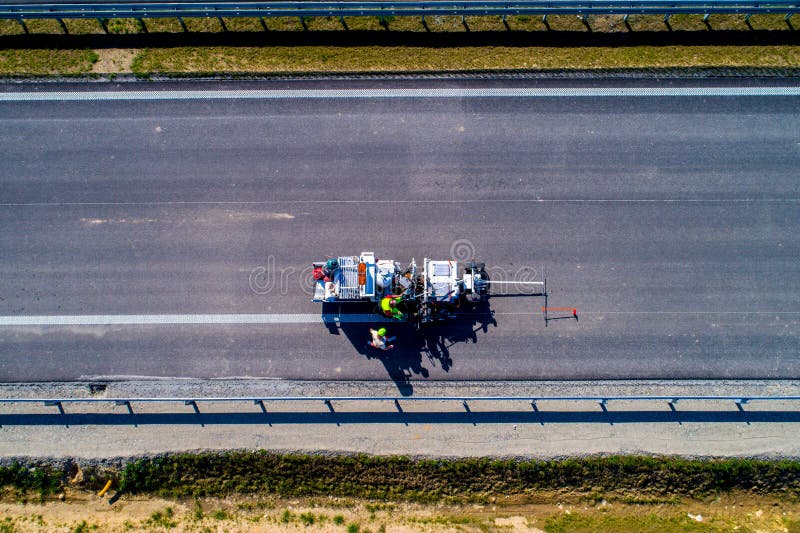 Workers painting the lines stock photo. Image of machine - 90648656