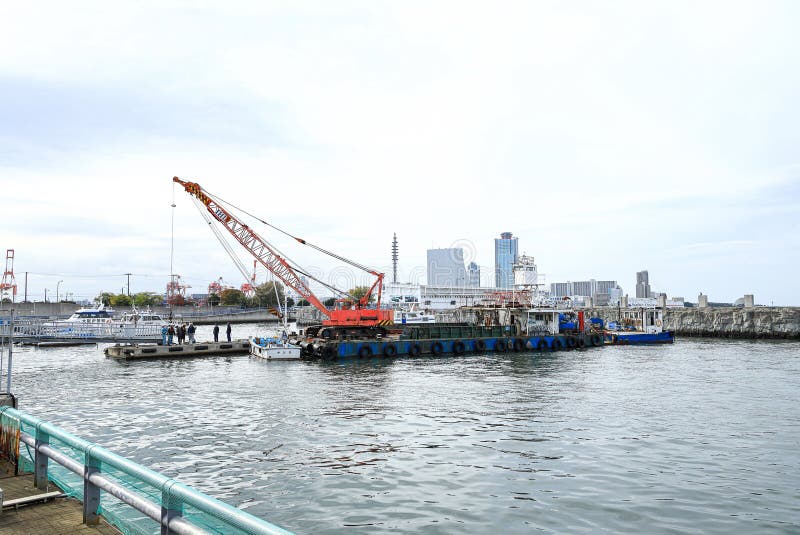 Workers Perform Maintenance on a Pier Support Structure in Osaka Port ...