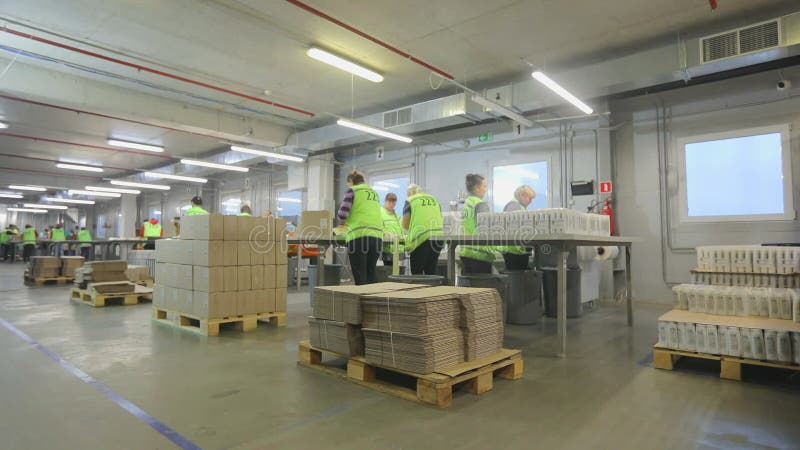 Workers Perform Work in a Large Warehouse. Warehouse Workflow. Modern ...