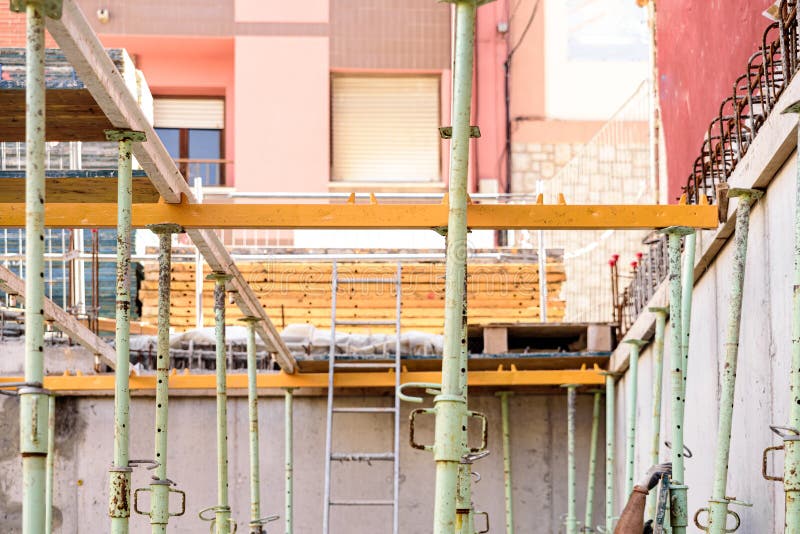 Workers Placing Support Bars To Cement the Structure of a Building with ...