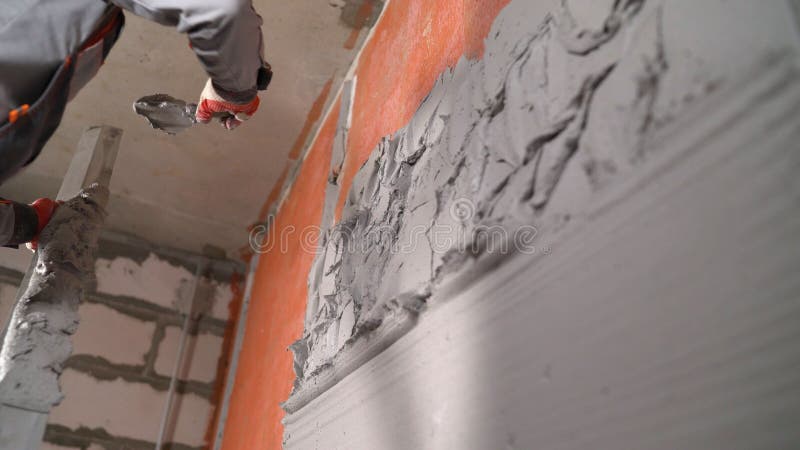 Workers are Plastered Walls. Hand Plasterer at Work. Application of the ...