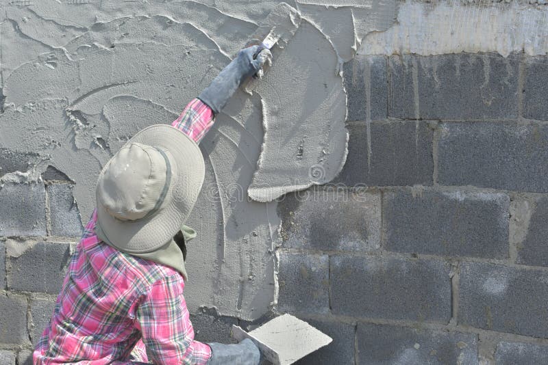 Workers Plastering a Brick Wall at a House Construction Site Stock ...