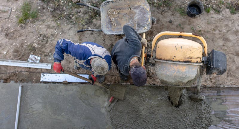 Workers Pour Concrete Solution at a Construction Site Stock Image ...