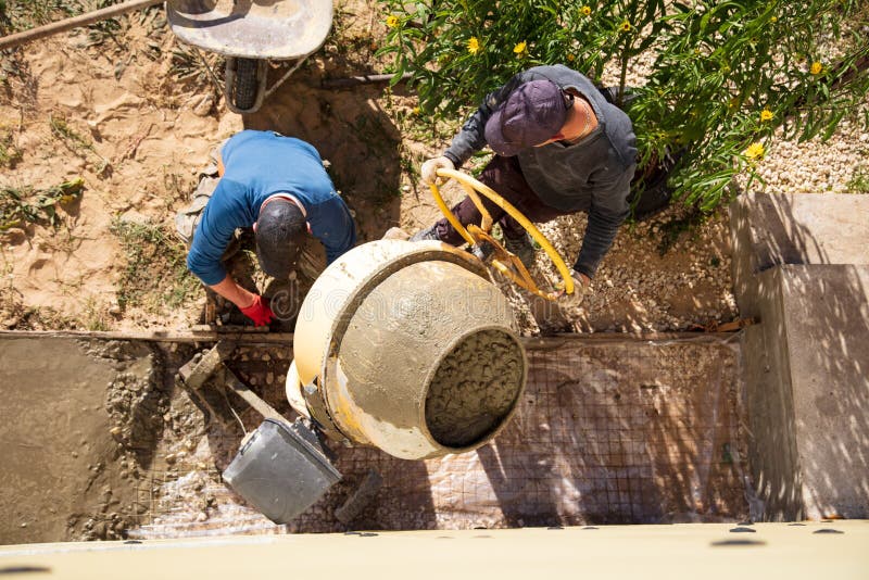 Workers Pour Concrete Solution at a Construction Site Stock Image ...