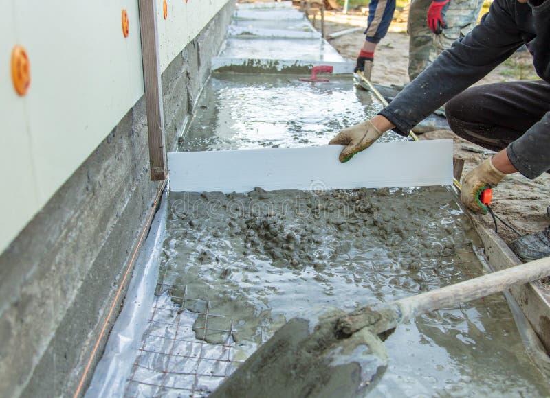 Workers Pour Concrete Solution at a Construction Site Stock Photo ...