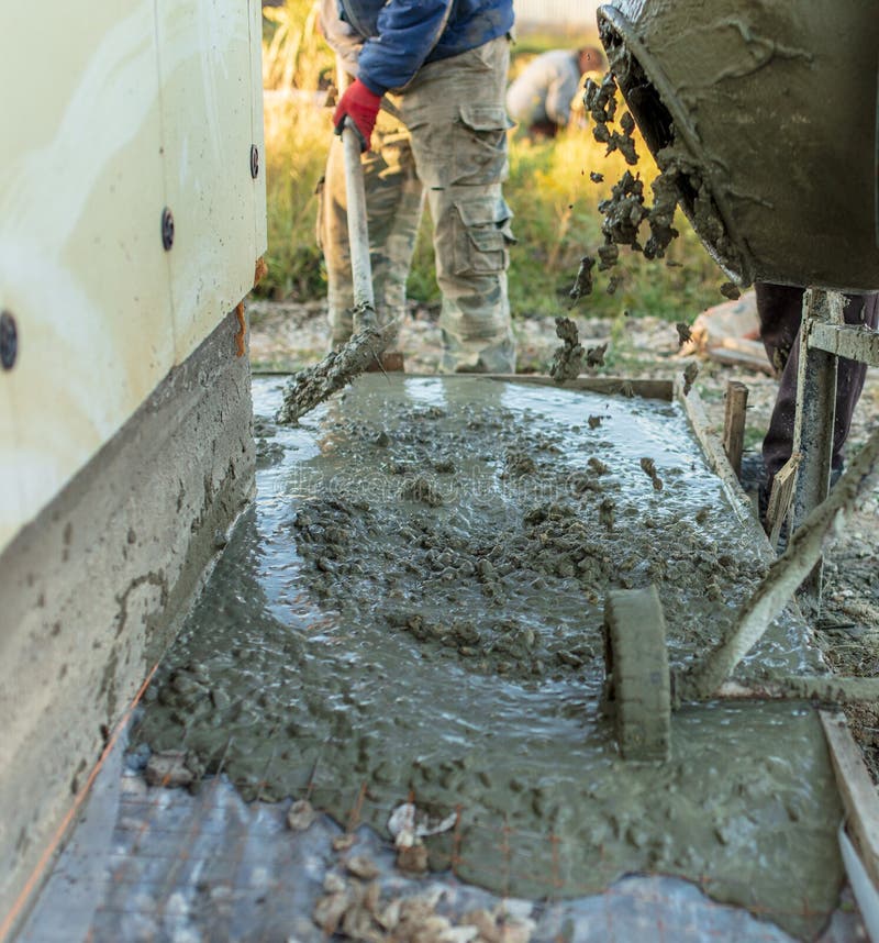 Workers Pour Concrete Solution at a Construction Site Stock Photo ...