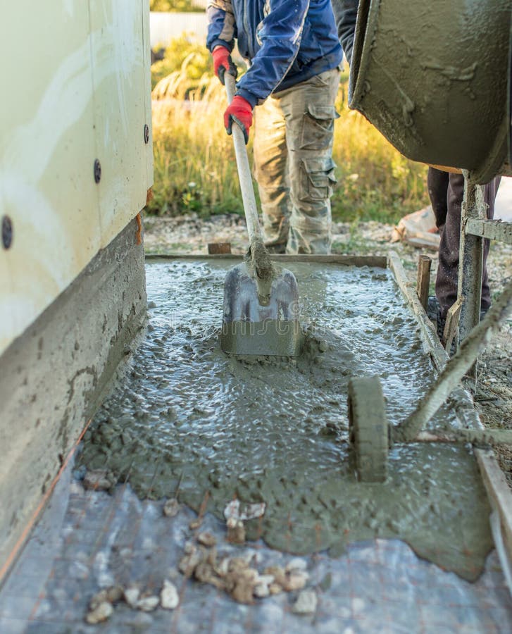 Workers Pour Concrete Solution at a Construction Site Stock Photo ...