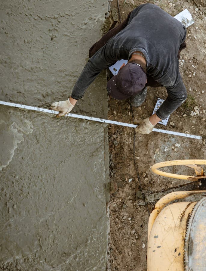 Workers Pour Concrete Solution at a Construction Site Stock Image ...