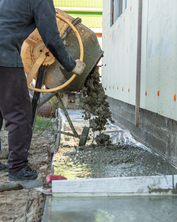 Workers Pour Concrete Solution at a Construction Site Stock Image ...