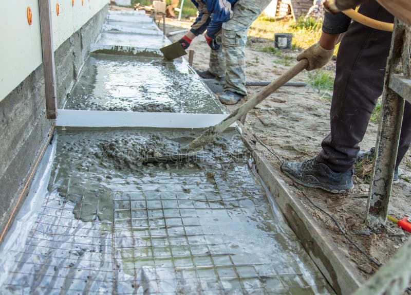 Workers Pour Concrete Solution at a Construction Site Stock Image ...