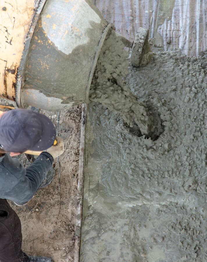 Workers Pour Concrete Solution at a Construction Site Stock Photo ...