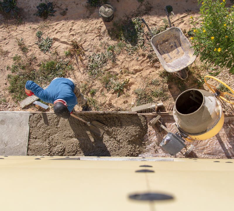 Workers Pour Concrete Solution at a Construction Site Stock Photo ...