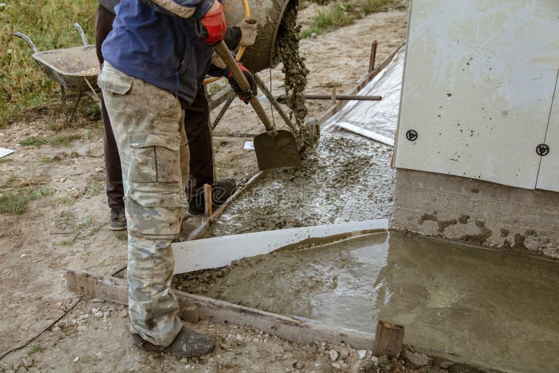 Workers Pour Concrete Solution at a Construction Site Stock Image ...