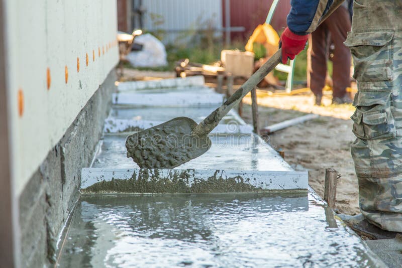 Workers Pour Concrete Solution at a Construction Site Stock Photo ...