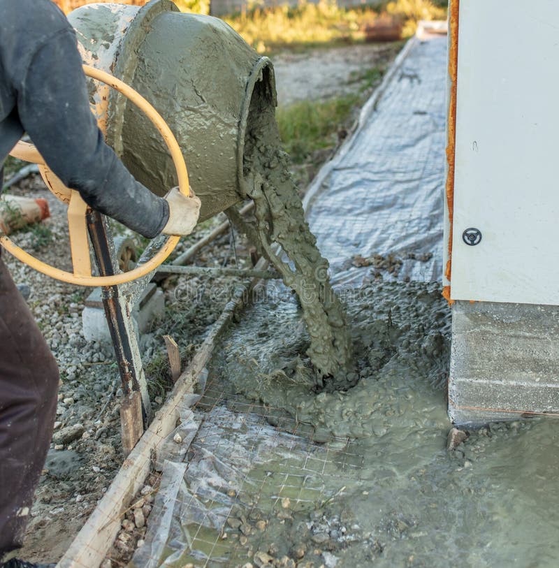 Workers Pour Concrete Solution at a Construction Site Stock Photo ...