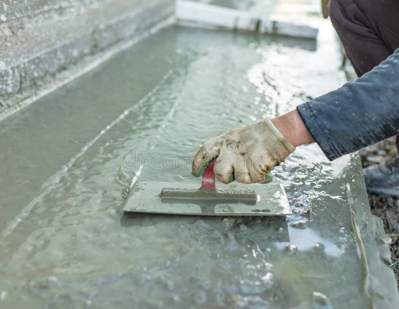Workers Pour Concrete Solution at a Construction Site Stock Photo ...