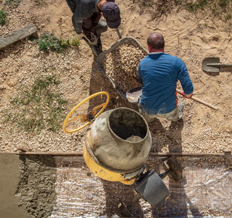 Workers Pour Concrete Solution at a Construction Site Stock Photo ...