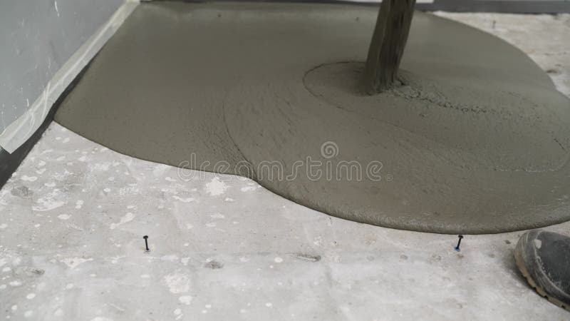 Workers Pour Solution from a Bucket Over the Concrete Floor. the ...