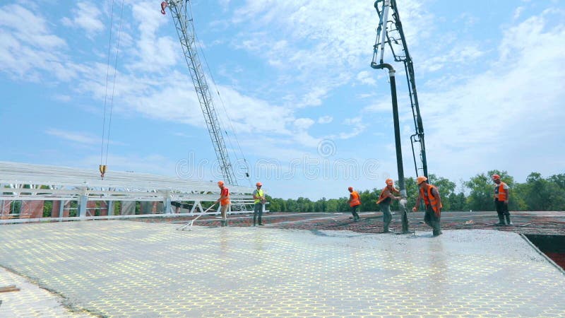 Workers are Pouring Concrete into the Metal Structure. Creating ...