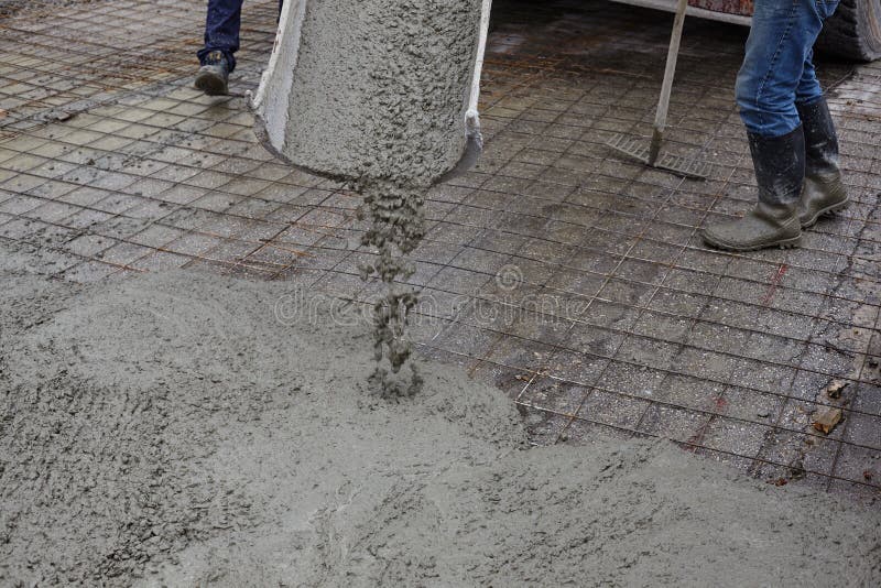 Workers Pouring Wet Concrete Using Concrete Bucket. Industrial ...