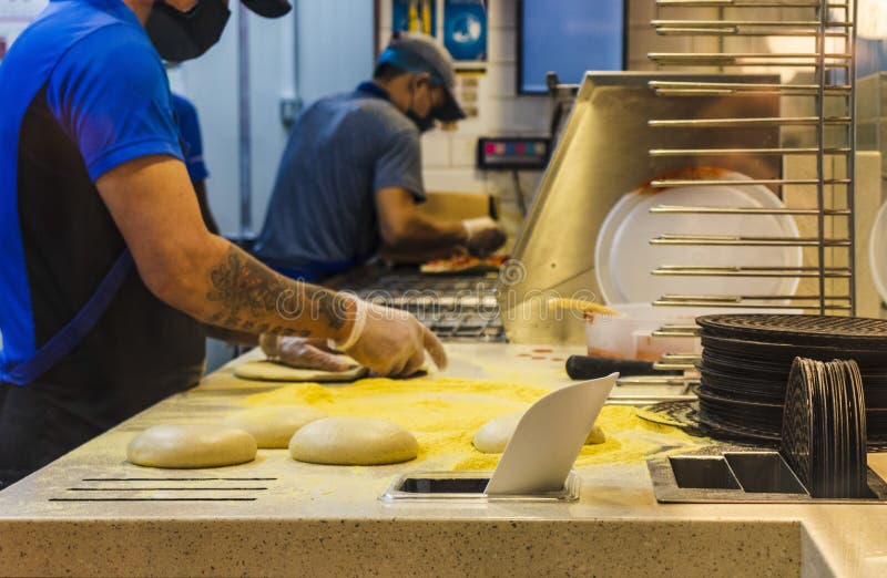 Workers Preparing Pizza in the Kitchen of the Restaurant. Food ...