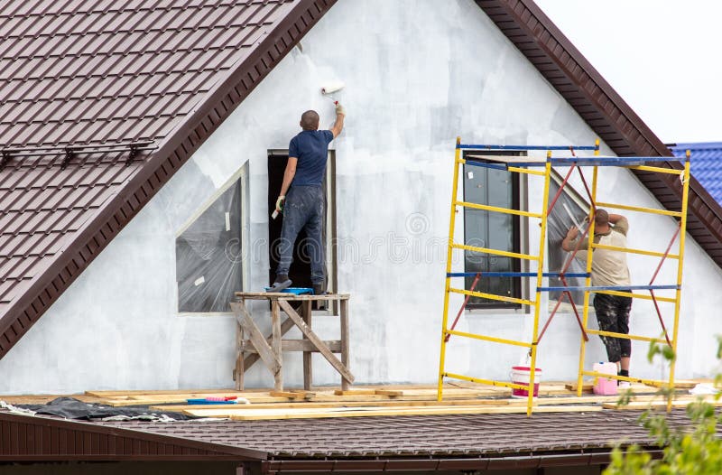 Workers are Priming Outside the Walls of the House. Editorial Photo ...