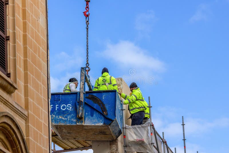 Workers on a Raised Platform, Lifting Off a Large, Rectangular ...